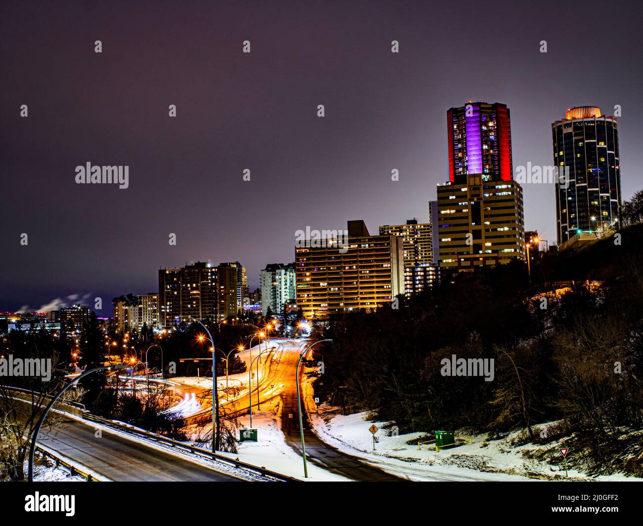 Beautiful scene of night streets, trees and urban colorful buildings ...