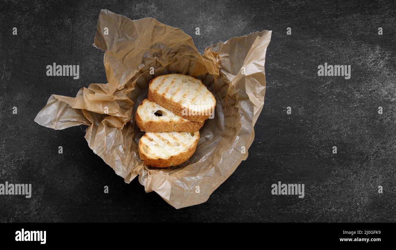 grilled white bread toasts on craft paper Stock Photo - Alamy