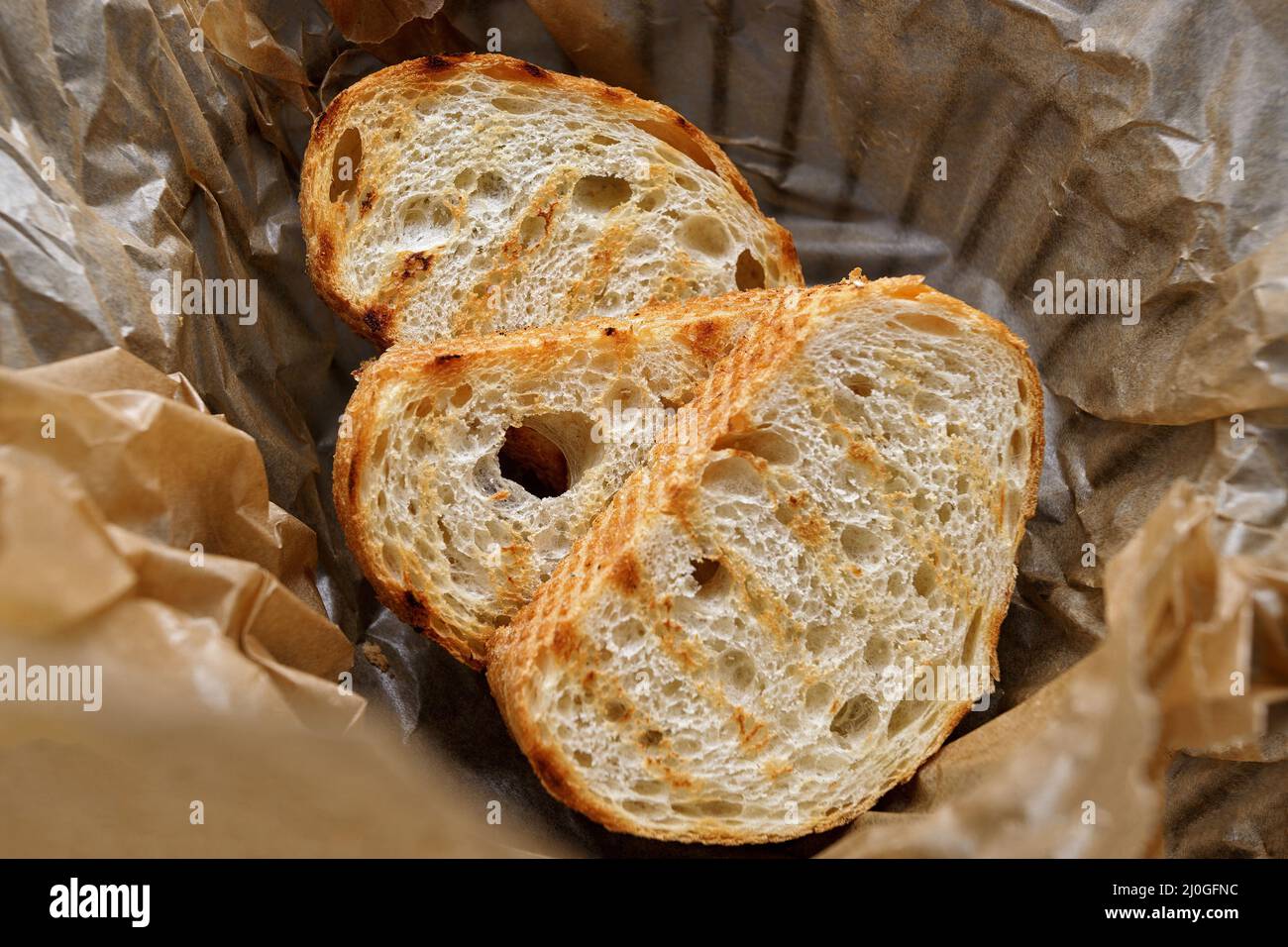 grilled white bread toasts on craft paper Stock Photo - Alamy