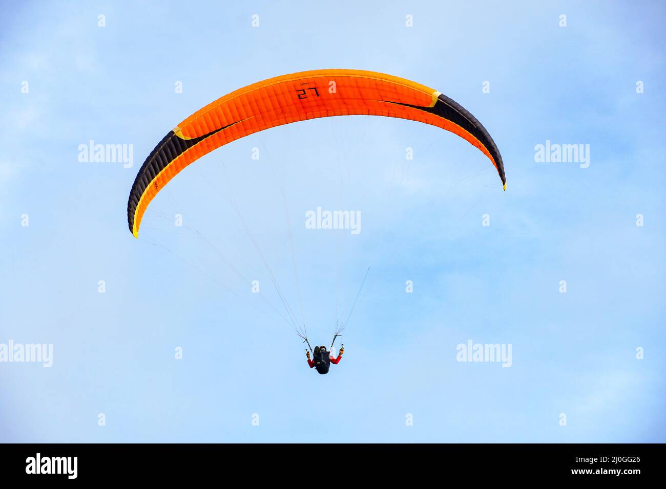 Man doing sport, Para-glider in the clouded sky Stock Photo - Alamy