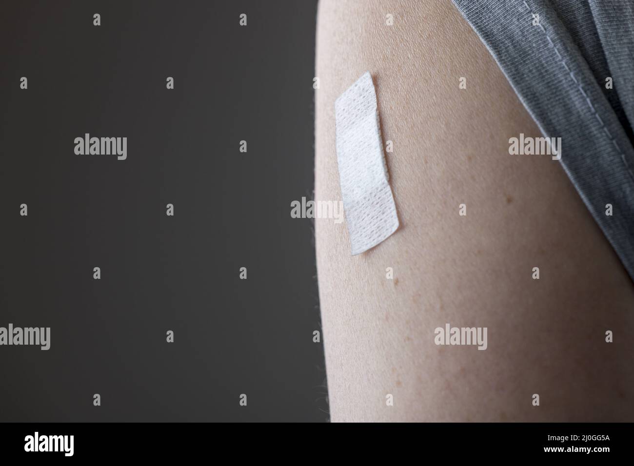 Patch on the arm after vaccination Stock Photo - Alamy