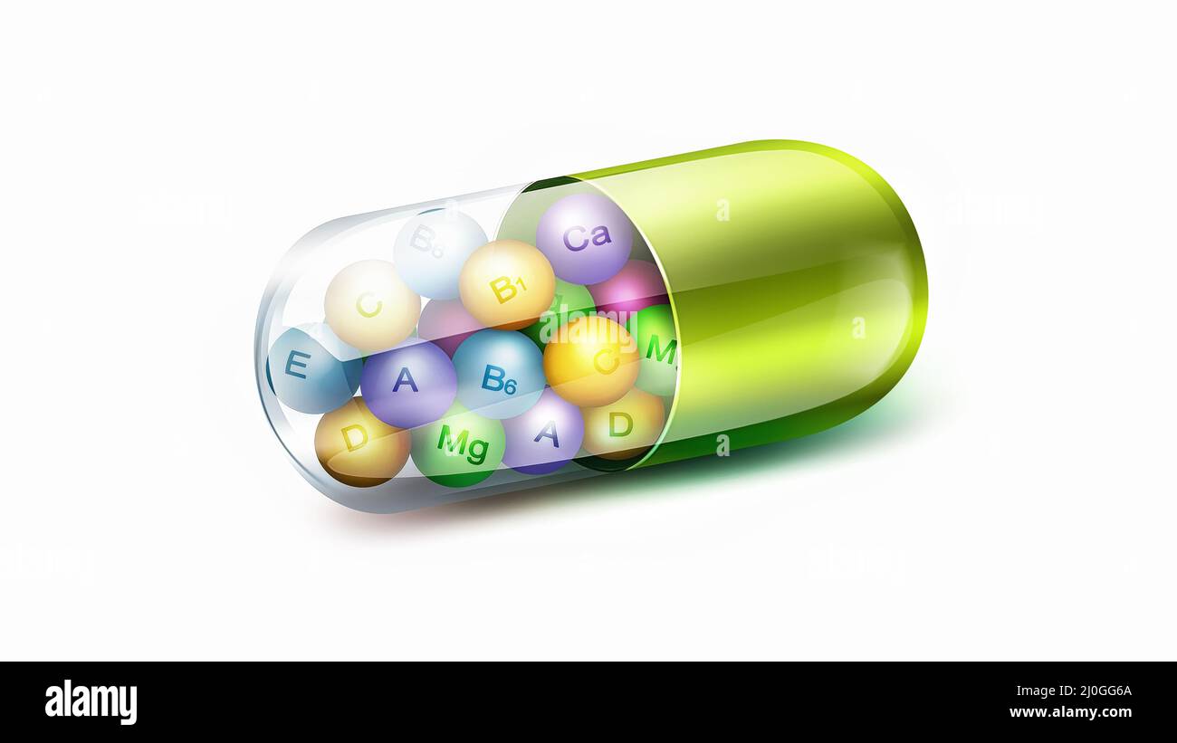 Big green pill with vitamins balls inside Stock Photo - Alamy
