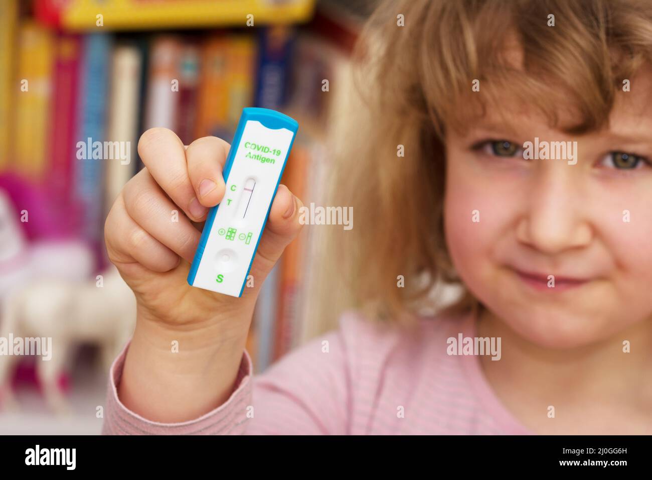 Child holds a negative corona antigen test in hand Stock Photo - Alamy