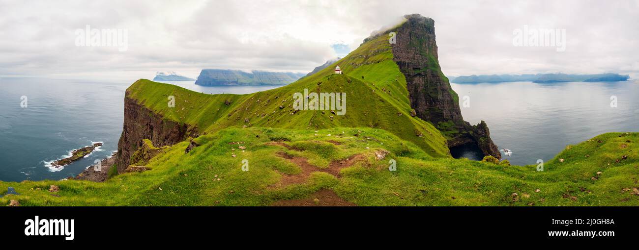 Beautiful view on Kallur lighthouse on the cliffs on the Kalsoy Island ...
