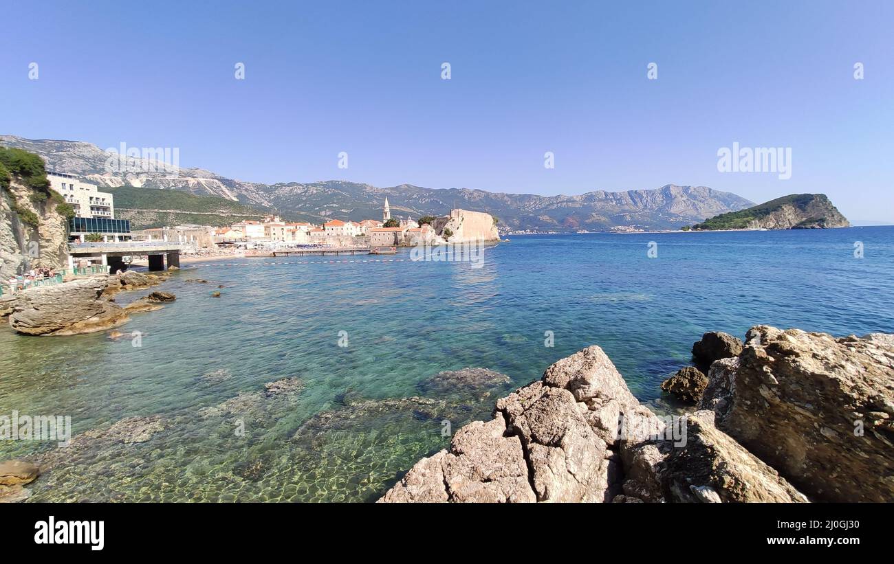 Beautiful view of an ocean with buildings and mountains in the ...