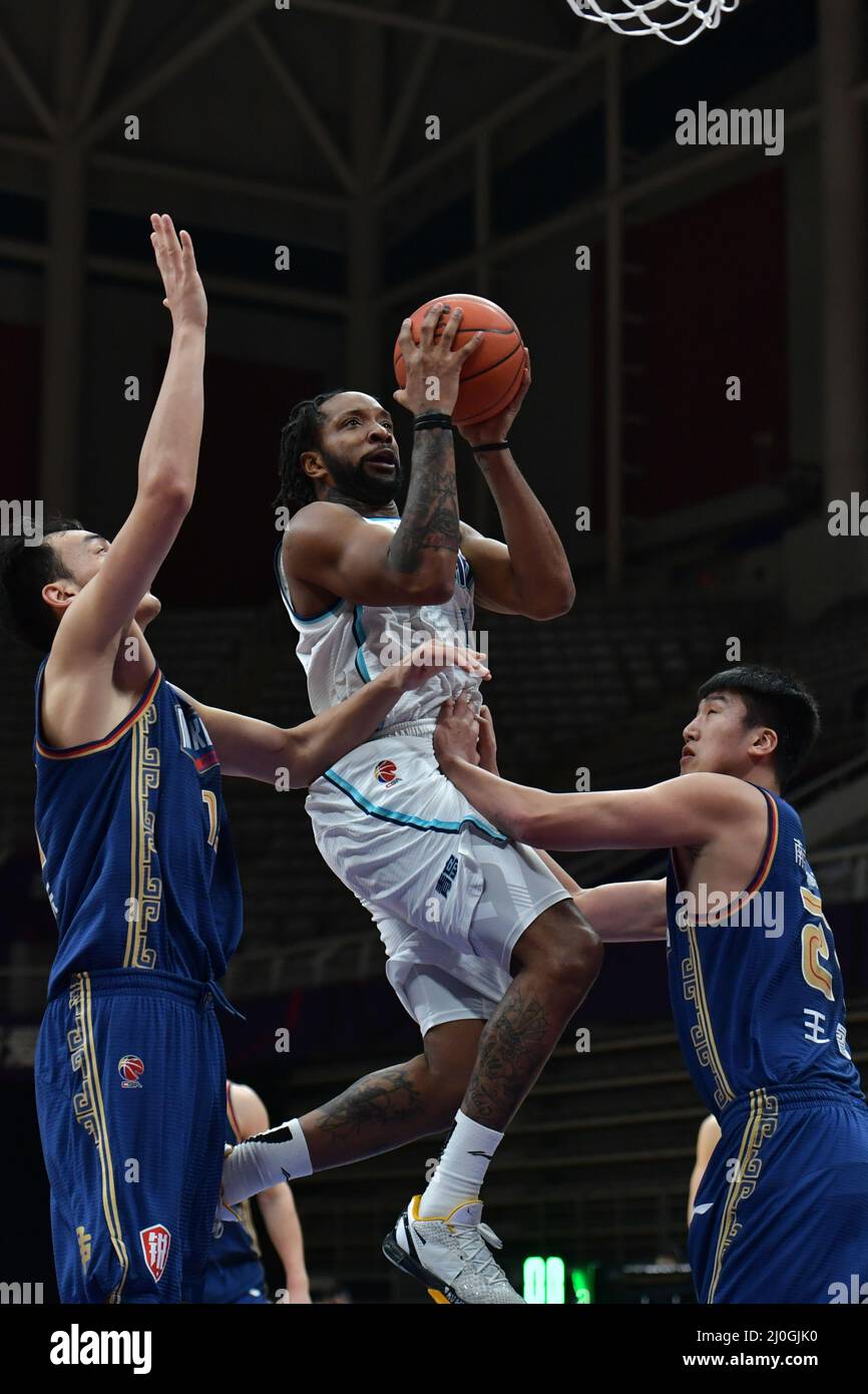 Shenyang. 19th Mar, 2022. Dezmine Wells (C) of Qingdao Eagles goes for ...