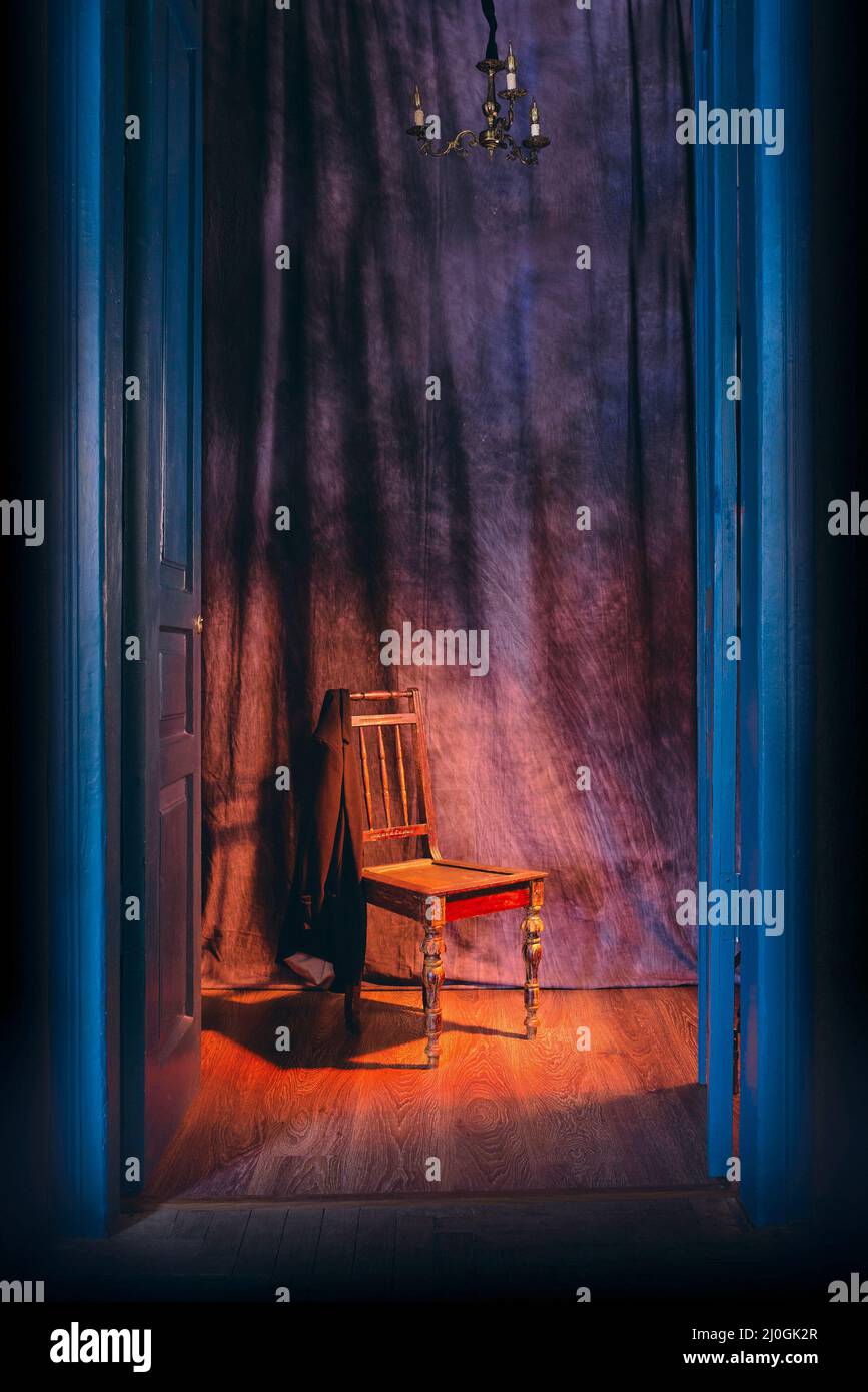 empty chair in light behind blue massive vintage doors indoor. Old ...