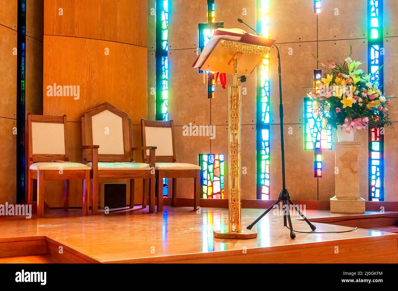 Stand with microphone and stained glass skylights in the background ...