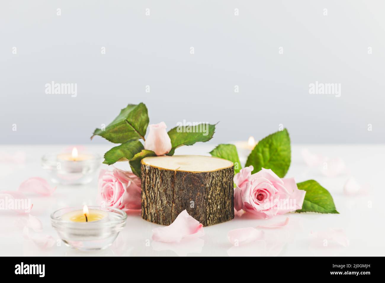 Natural product display on neutral light grey background with flowers ...