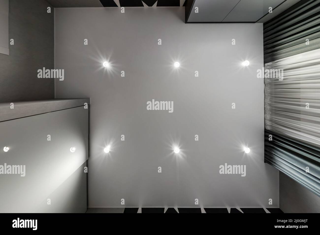 suspended ceiling with halogen spots lamps and drywall construction in ...