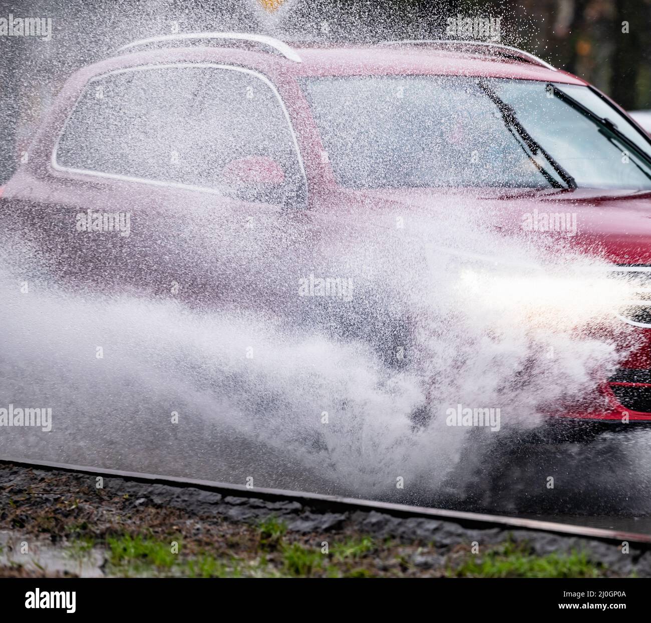 Car rain puddle splashing water Stock Photo - Alamy
