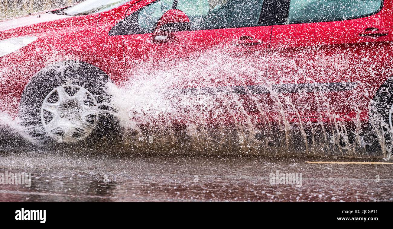 Car rain puddle splashing water Stock Photo - Alamy