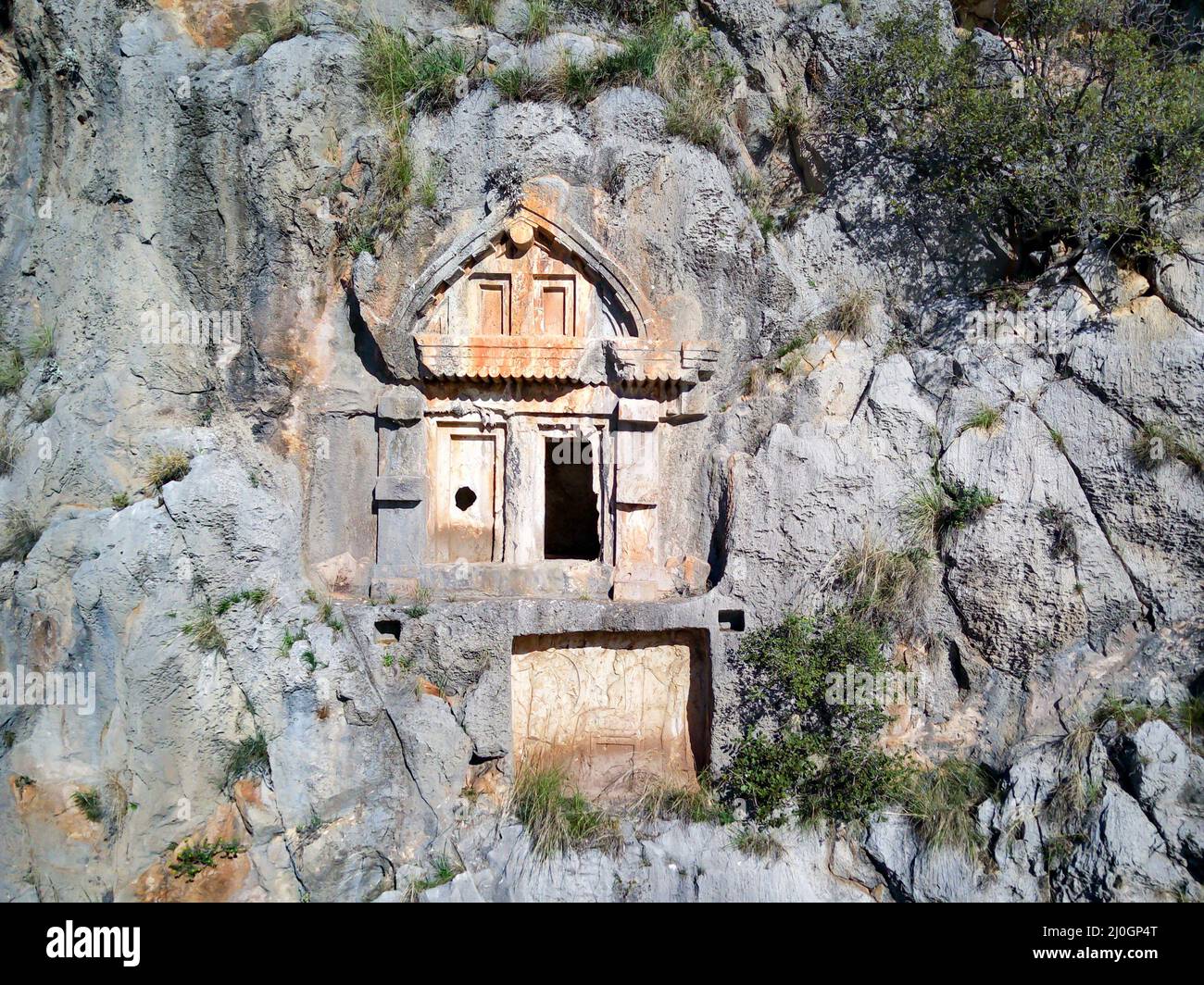 High angle drone aerial view of ancient greek rock cut tombs carved ...