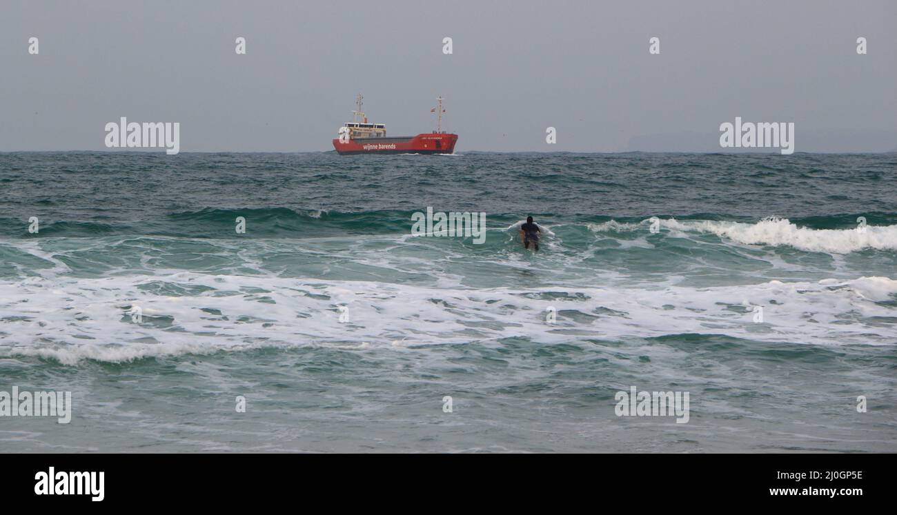 Lady Alexandra cargo ship manoeuvring to anchor off the beach with a ...
