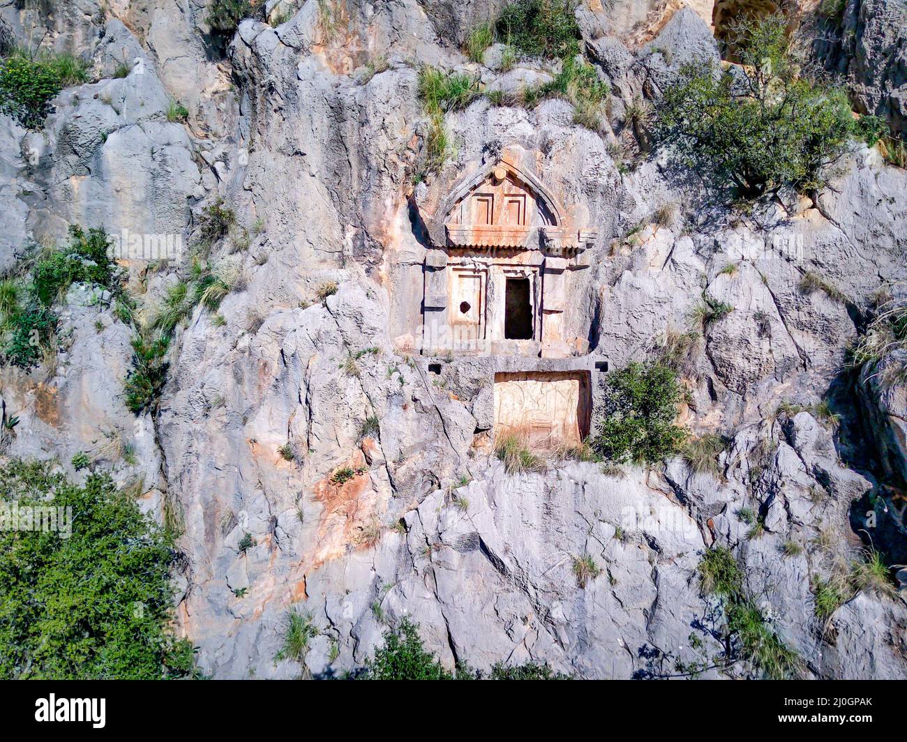 High angle drone aerial view of ancient greek rock cut tombs carved ...