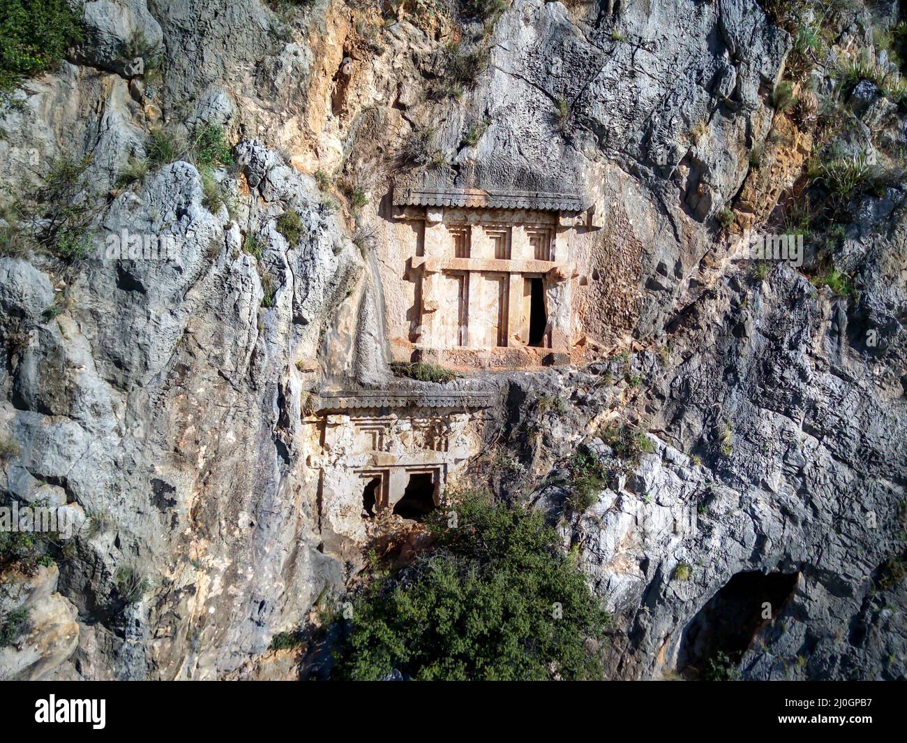 High angle drone aerial view of ancient greek rock cut tombs carved ...