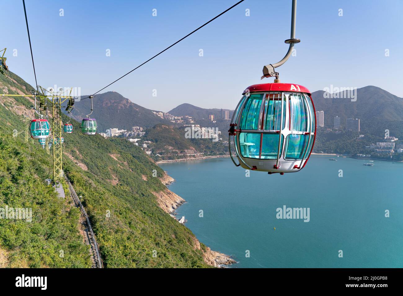 The sunny view of cable car and theme park near to ocean Stock Photo ...