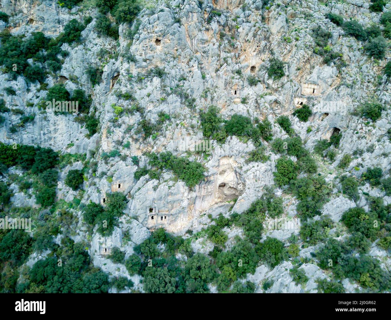 High angle drone aerial view of ancient greek rock cut tombs carved ...