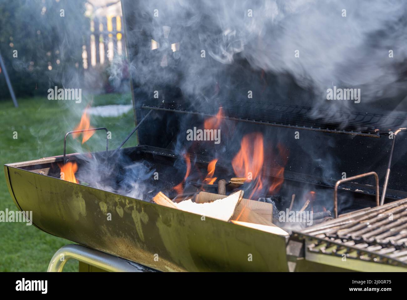 Smoke and flame in the charcoal grill - light a fire in the grill Stock ...