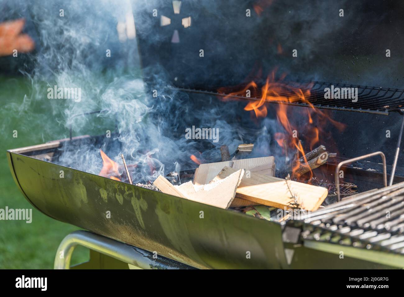 Light a fire in the charcoal grill - barbecue fire Stock Photo - Alamy