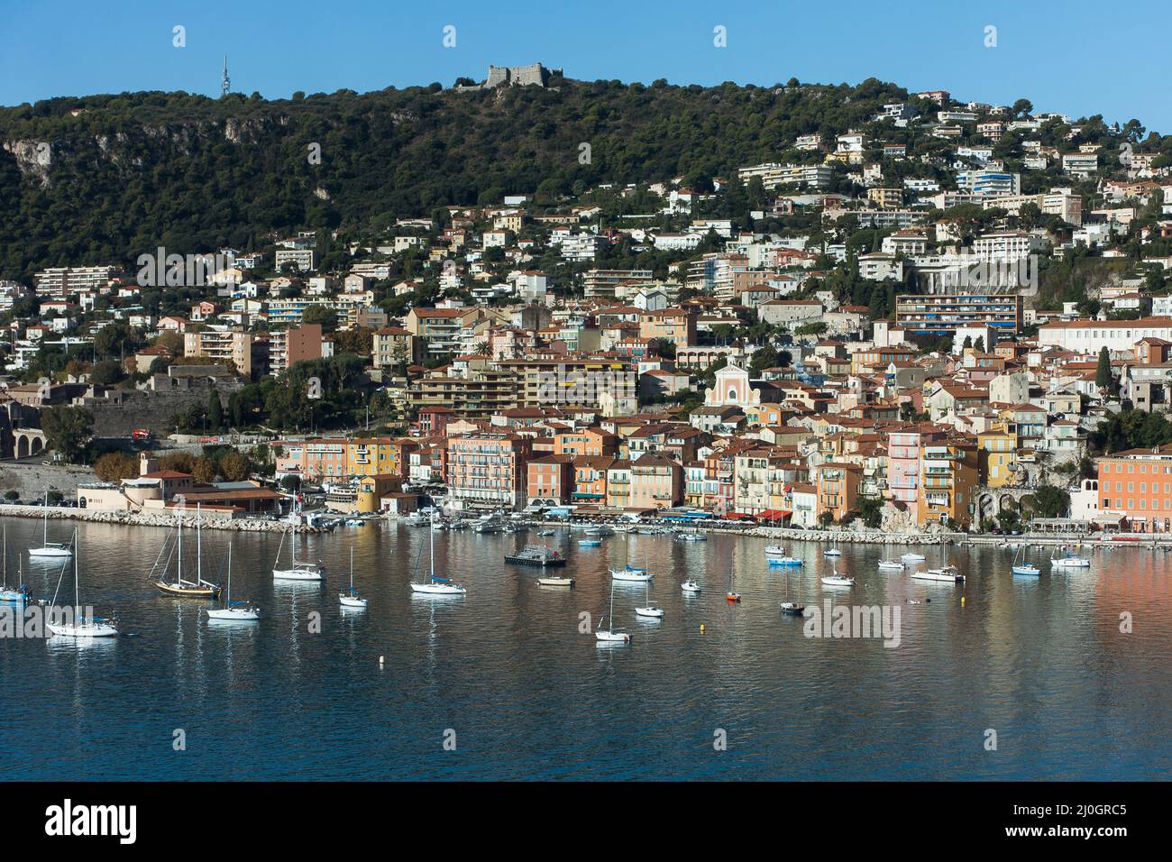 Blue sea with small luxury yachts and boats with cute European French ...