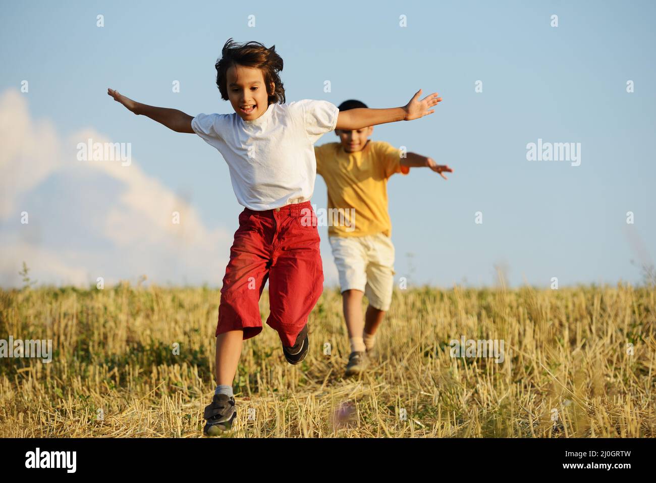 Two kids on meadow Stock Photo - Alamy