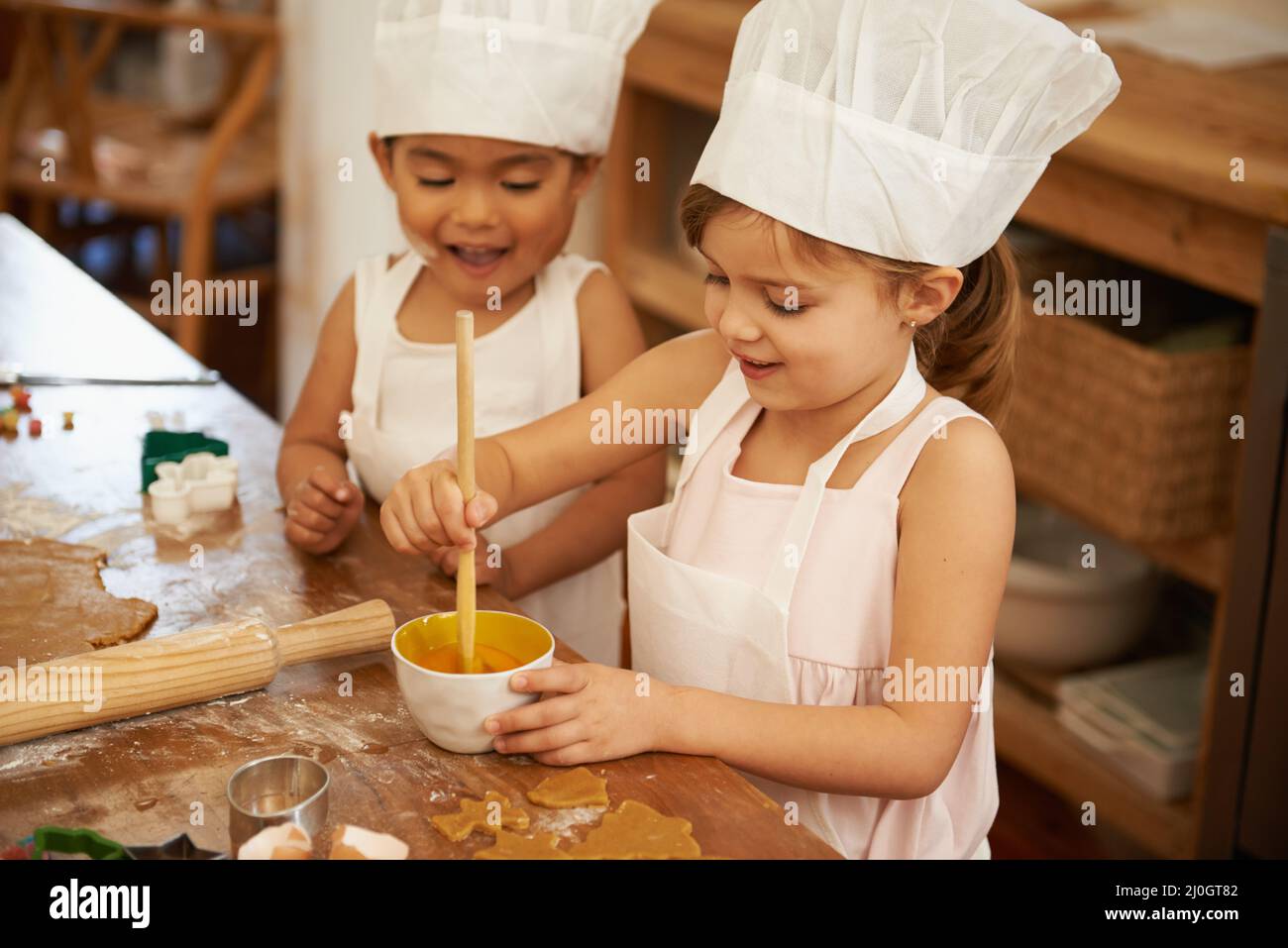 Baking is so much fun. Two little girls having fun while baking in the ...