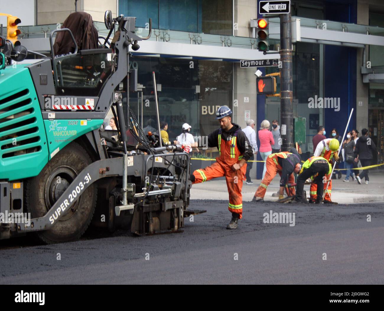 View of workers repairing a road with trucks in downtown Vancouver ...