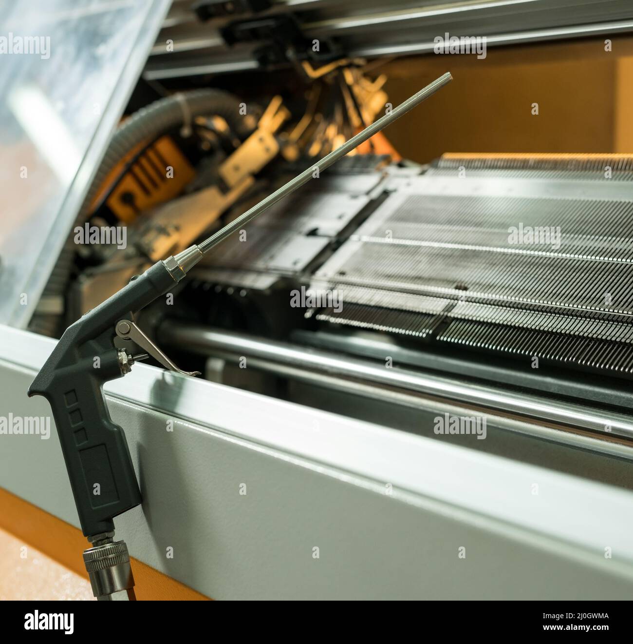 Knitting machine at the factory cropped shot Stock Photo - Alamy