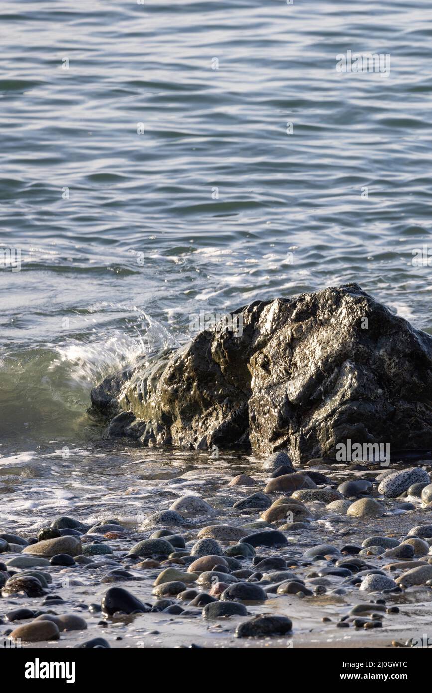 wave crashing intro rocks on pacific northwest beach Stock Photo - Alamy