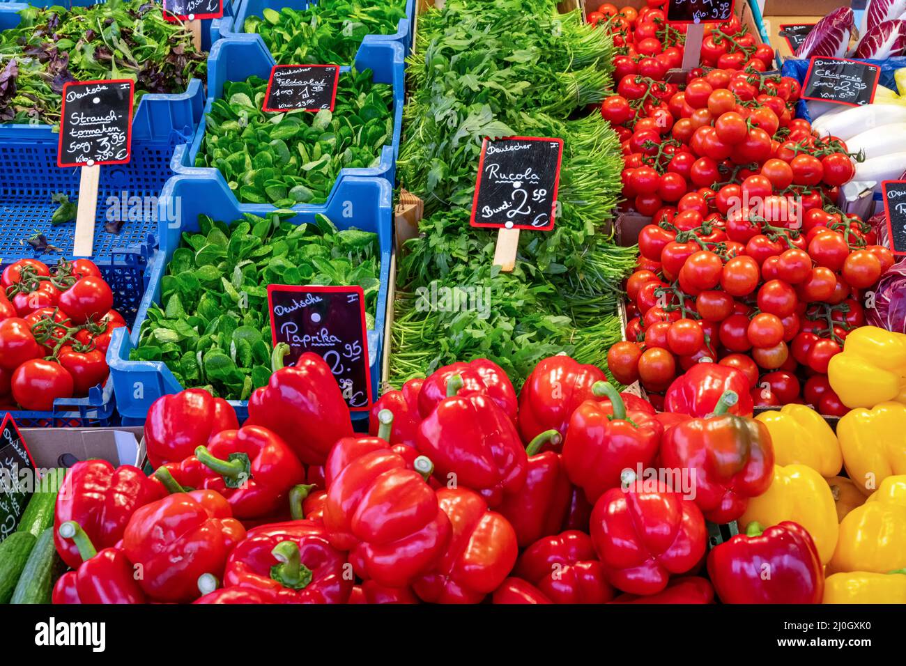 Bell pepper, rocket salad and tomatoes for sale at a market Stock Photo ...