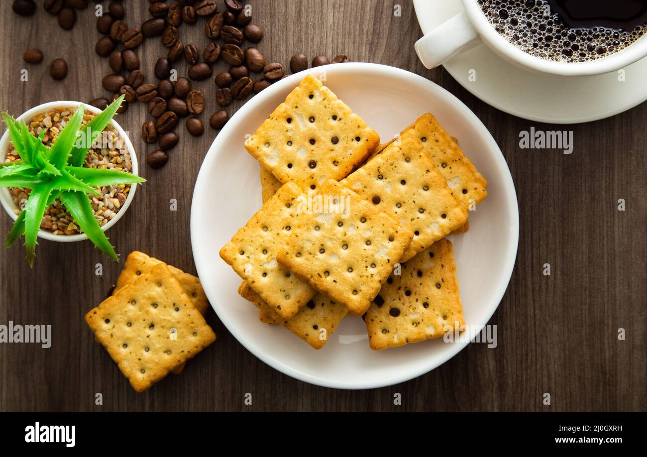 Biscuit with chocolate filling on wooden table Stock Photo - Alamy