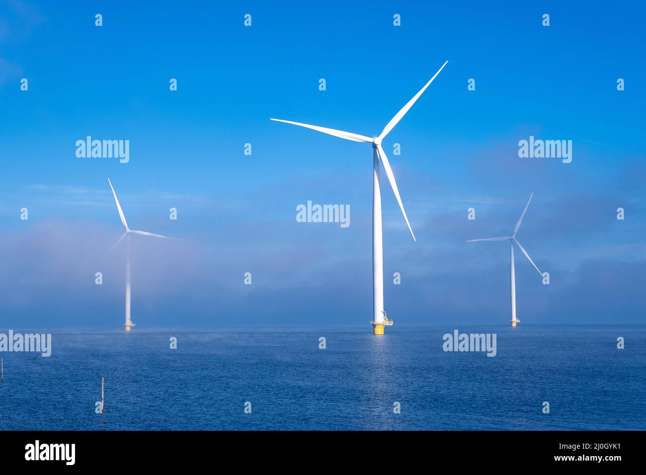 Offshore windmill park with clouds and a blue sky, windmill park in the ...