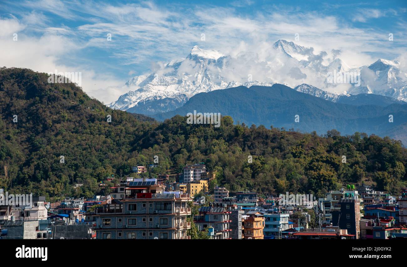 Pokhara cityscape with the Annapurna mountain range covered in snow at ...