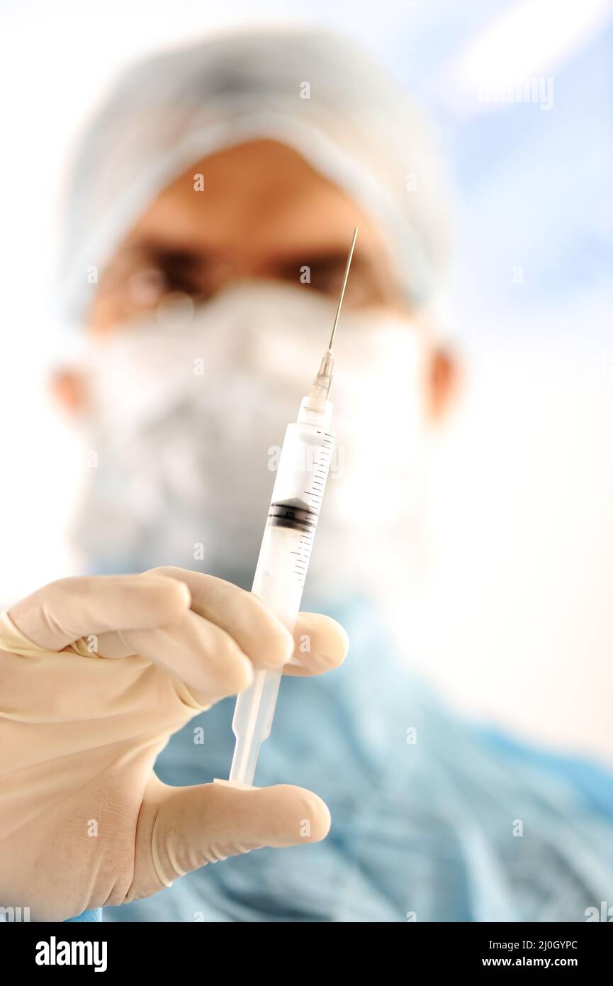 Doctor holding injection vaccine Stock Photo - Alamy