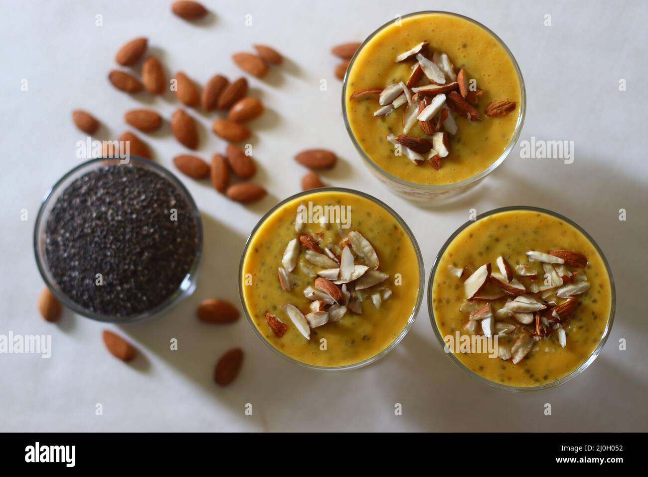 Milkshake with alphonso mango and chia seeds, garnished with sliced ...