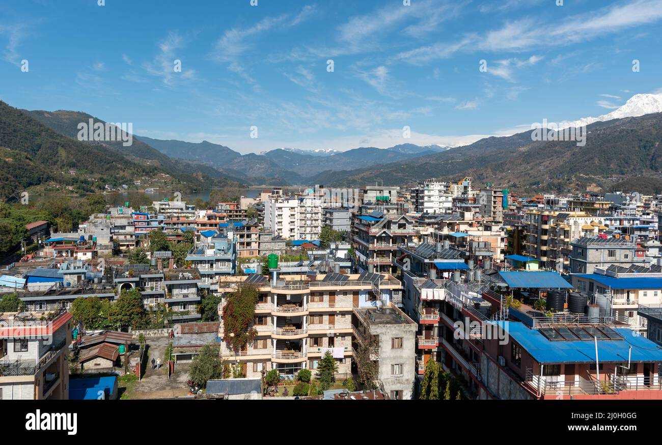 Cityscape of Pokhara with the Annapurna mountain range covered in snow ...