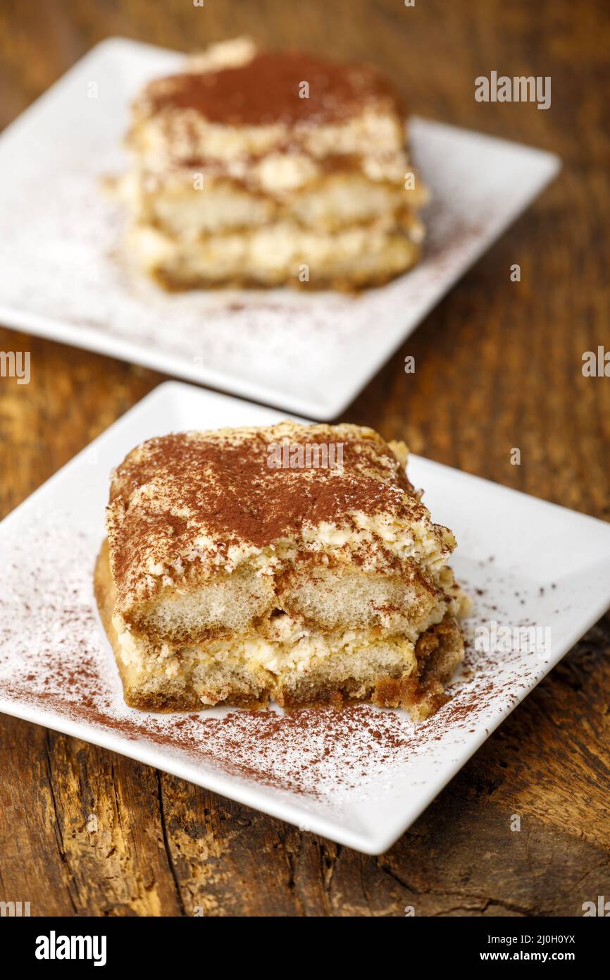 Tiramisu on white plates Stock Photo - Alamy