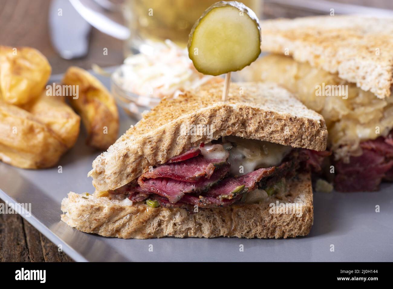 Reuben Sandwich on rustic wood Stock Photo - Alamy