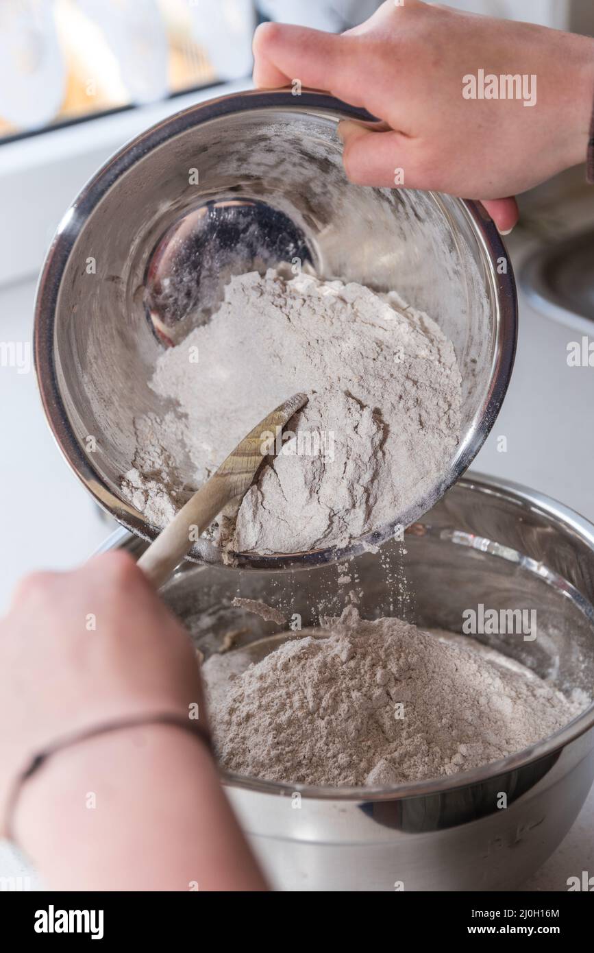 Homemade bread - mix flour into the bread dough Stock Photo - Alamy