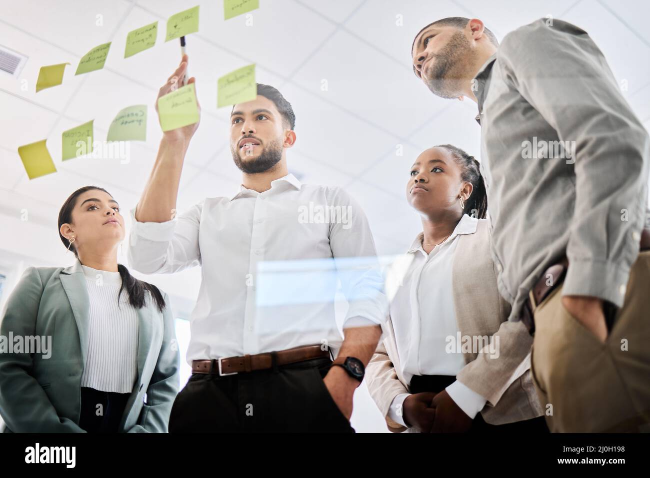 Setting the right strategy in place. Low angle shot of a group of ...