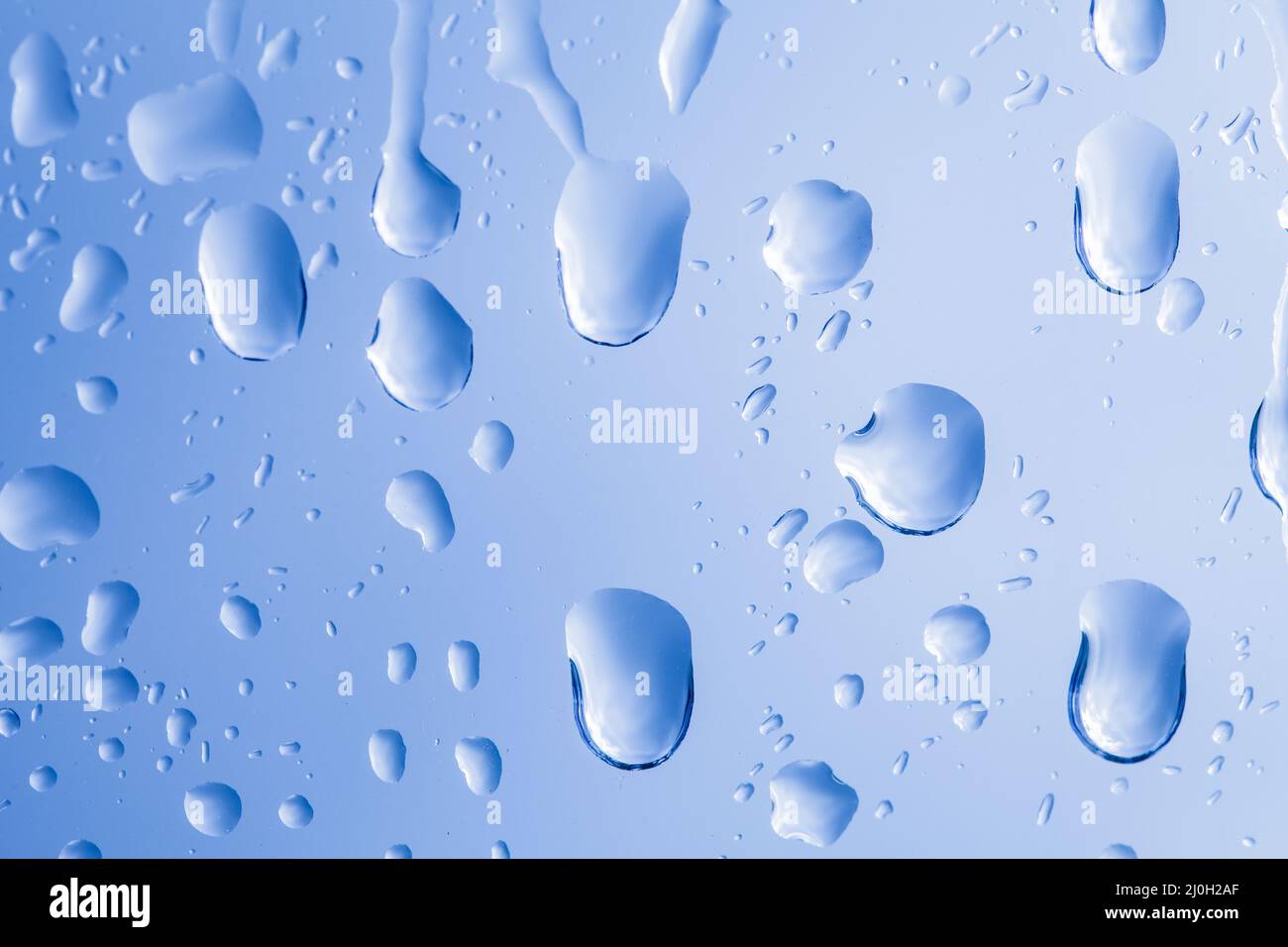 Blue rain drops on a window Stock Photo - Alamy