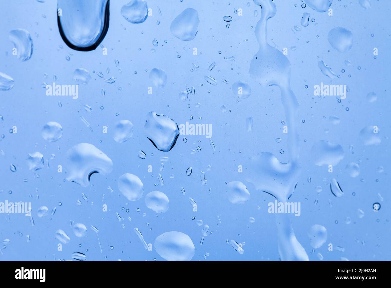 Blue rain drops on a window Stock Photo - Alamy