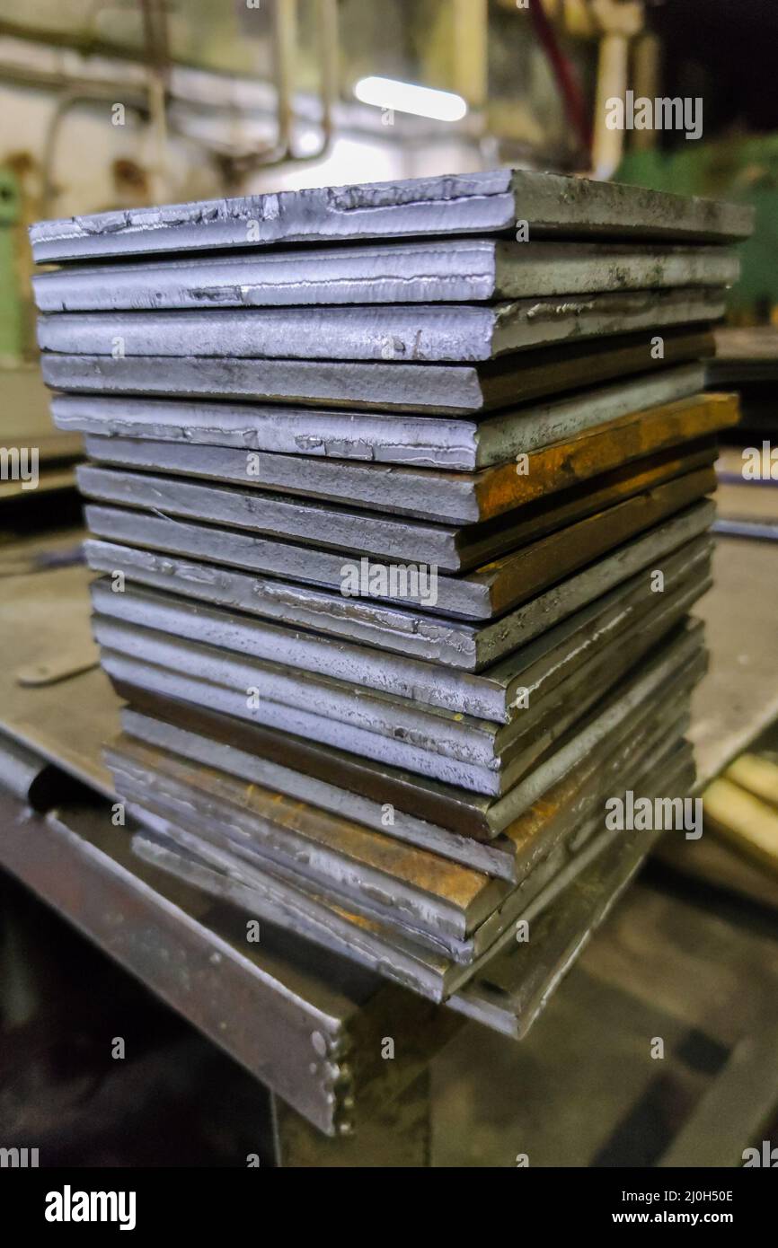 stack of rectangular thick sheet steel card workpieces, cut with ...
