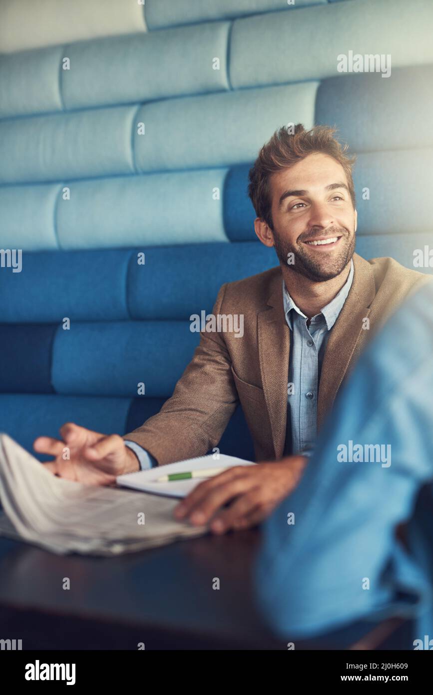 Networking his way to success. Shot of a young man having a business ...