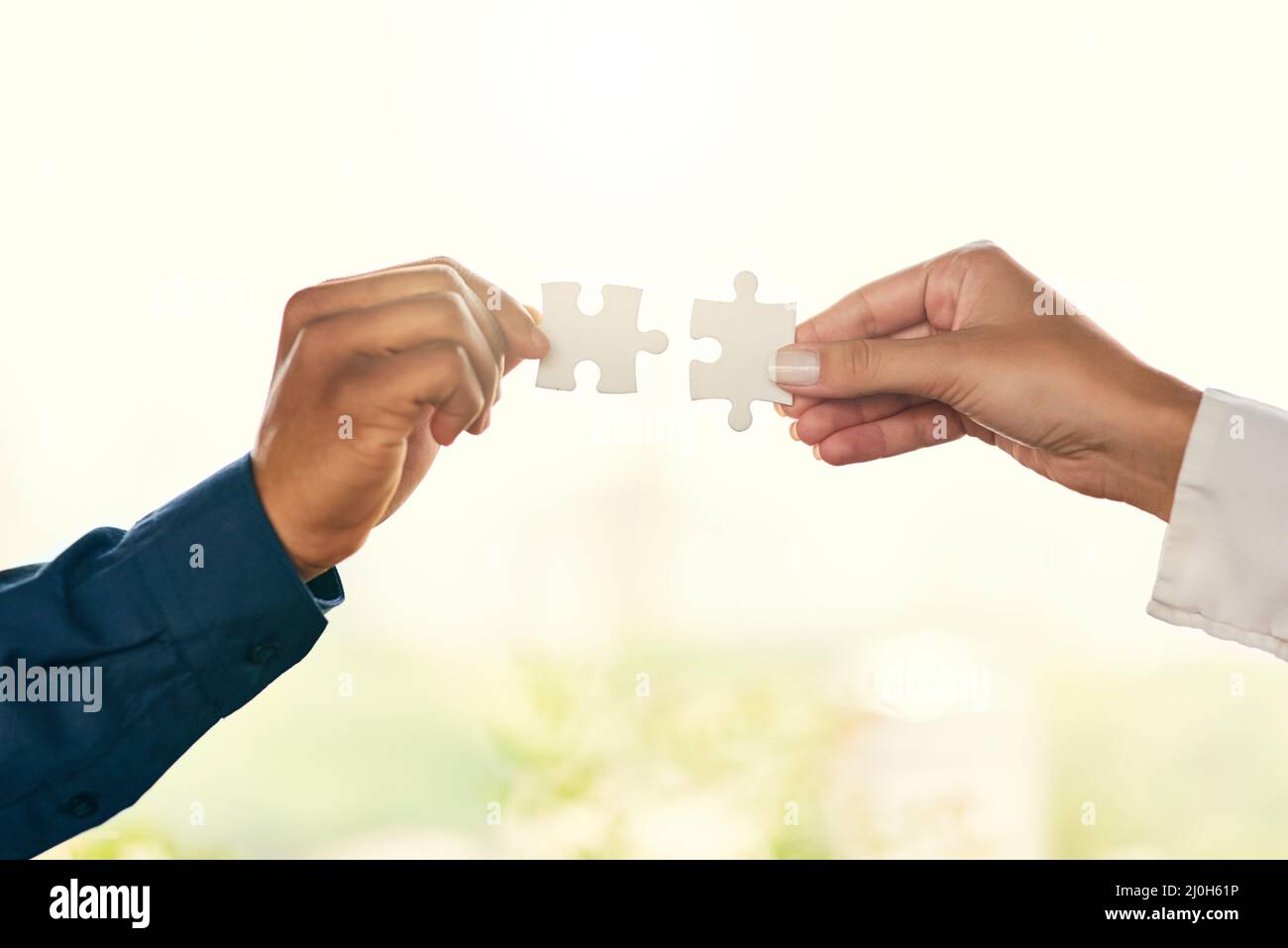 Pulling together to solve a problem. Closeup shot of two unrecognizable ...