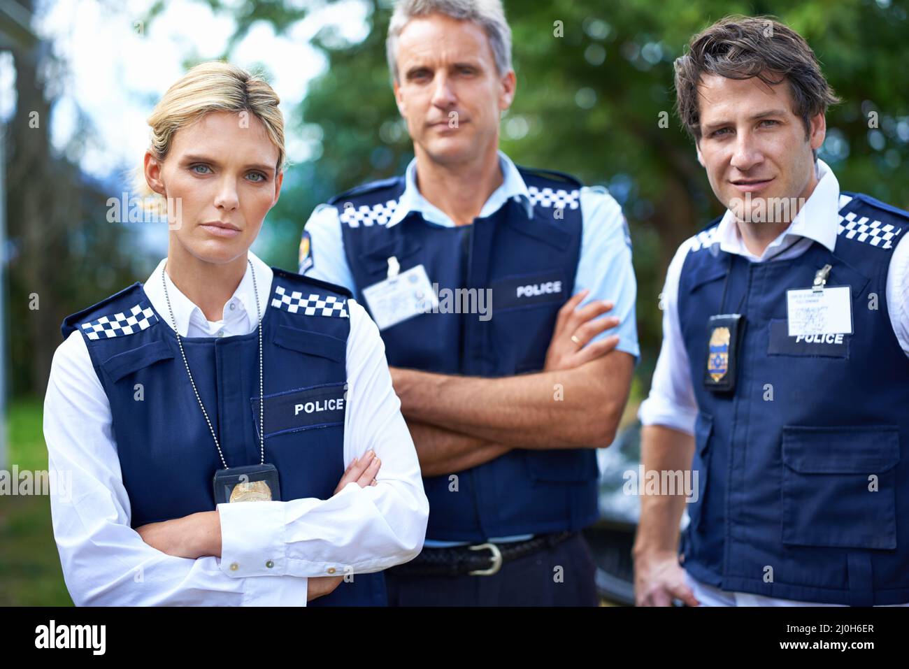 The officers are on it. Cropped shot of three serious members of the ...