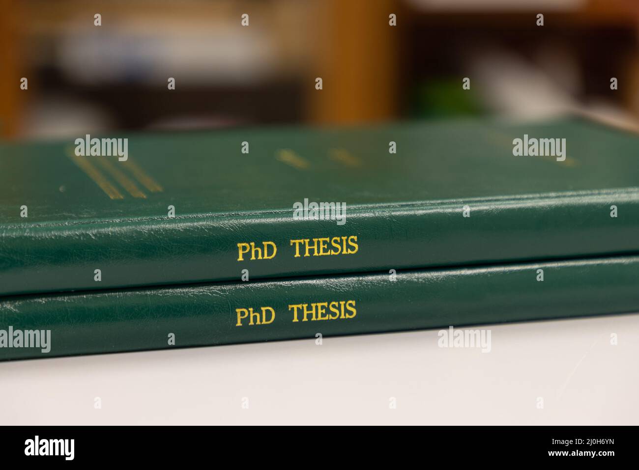 a pile of PhD theses of green cover, office or library background Stock ...