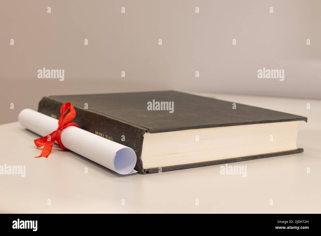 a PhD thesis of green cover with a diploma or certificate on desk Stock ...