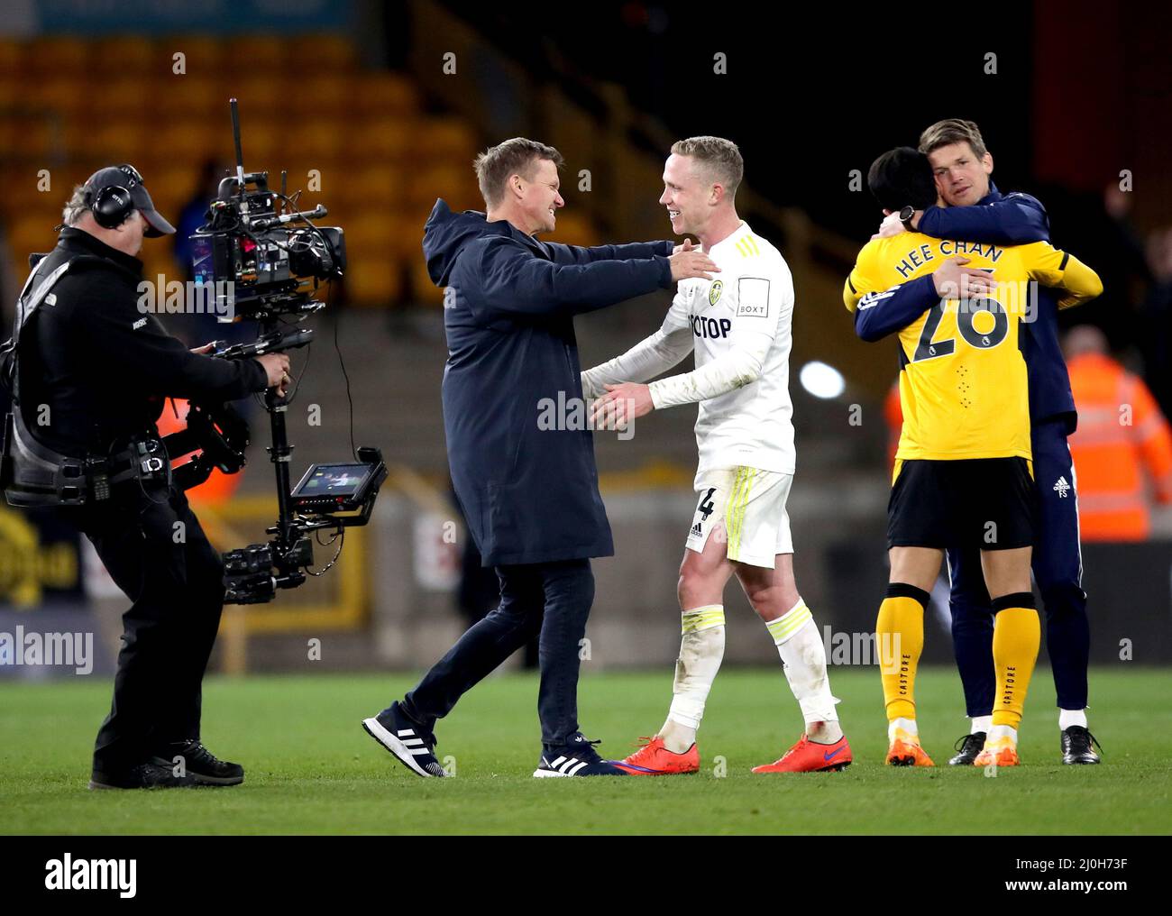 Leeds United manager Jesse Marsch (left) hugs Adam Forshaw at the end ...
